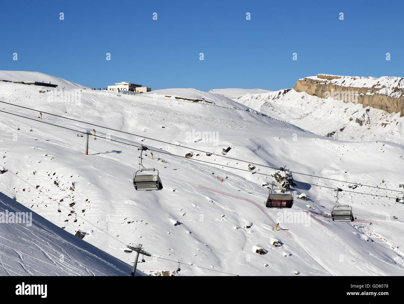 Ski slope and chair-lift at sun day. Greater Caucasus, Mount Shahdagh ...