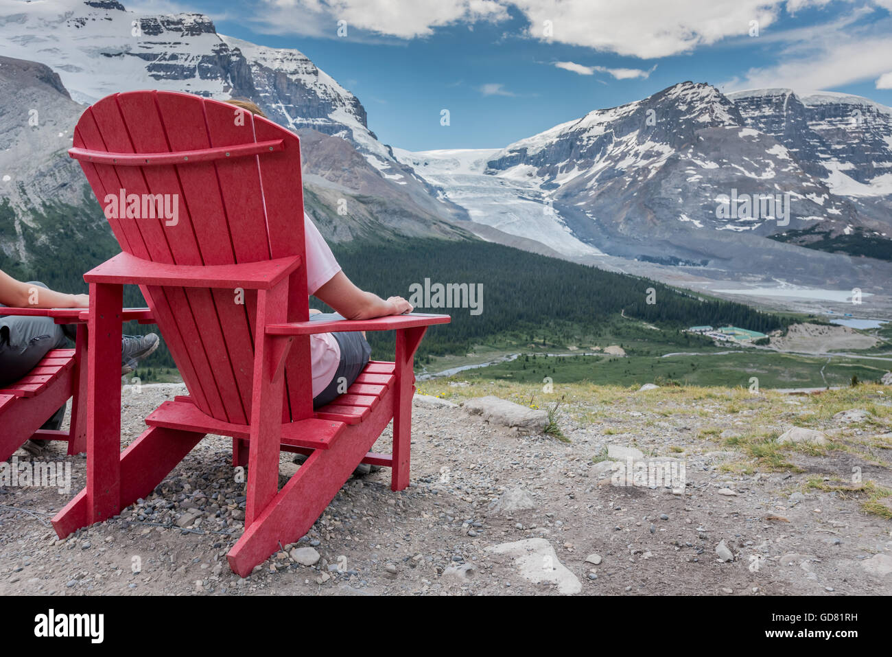 Behind View of Woman Sitting In Chair Enjoying the View in the Canadian ...