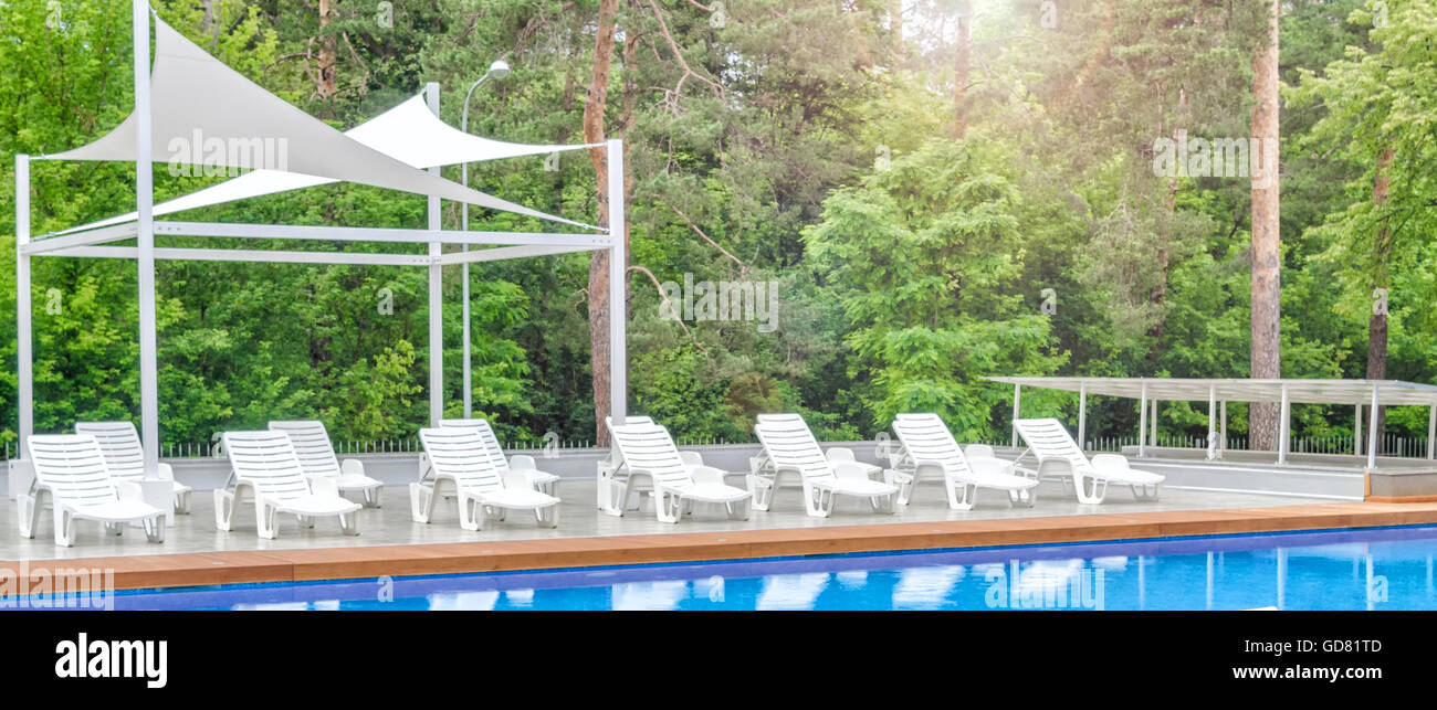 clean swimming pool and empty resting chair Stock Photo - Alamy