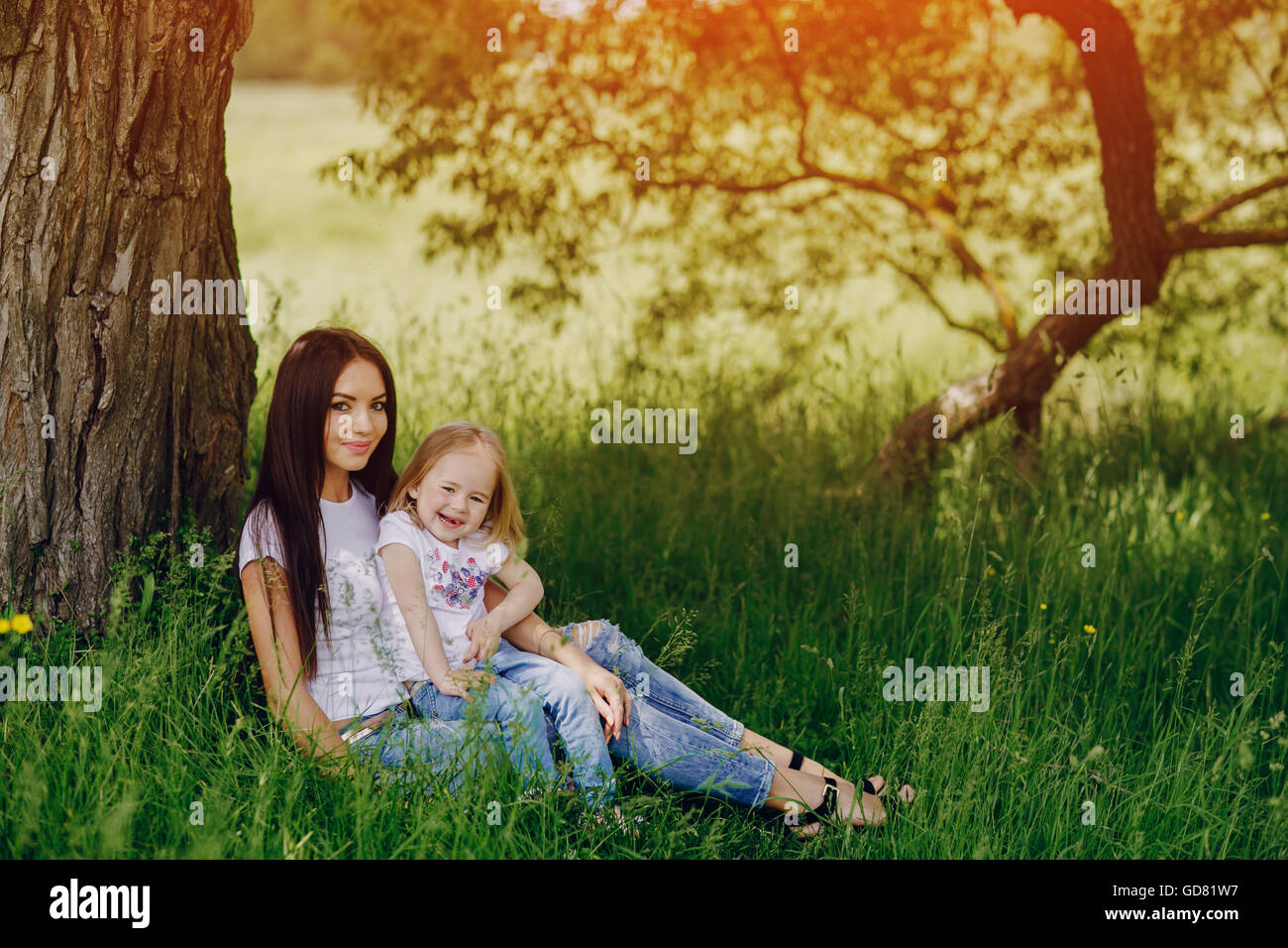 child near tree with mom Stock Photo - Alamy