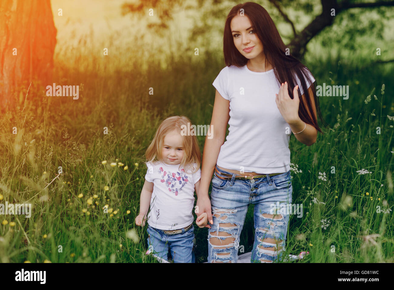 child near tree with mom Stock Photo - Alamy