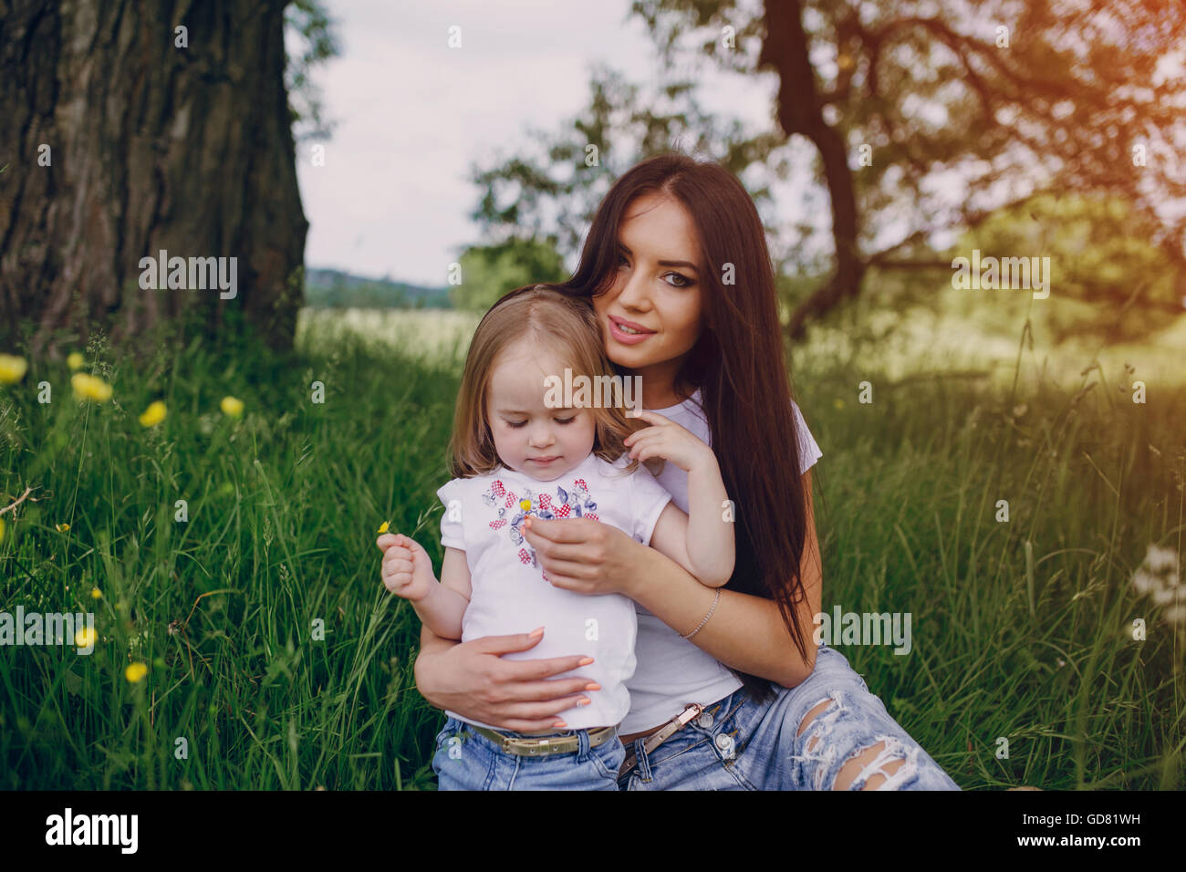 child near tree with mom Stock Photo - Alamy
