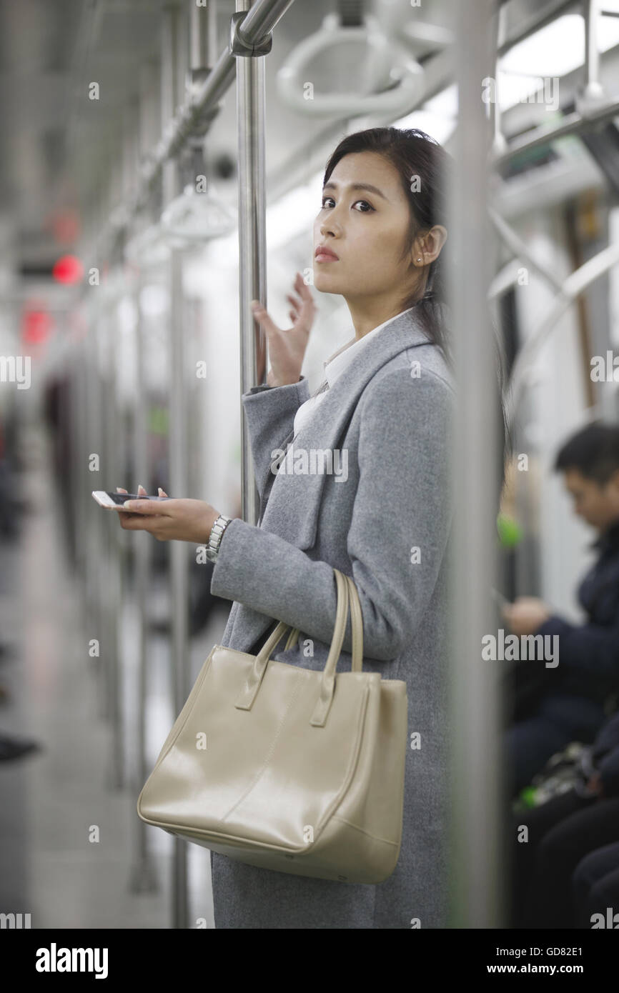 Young women take the subway Stock Photo - Alamy