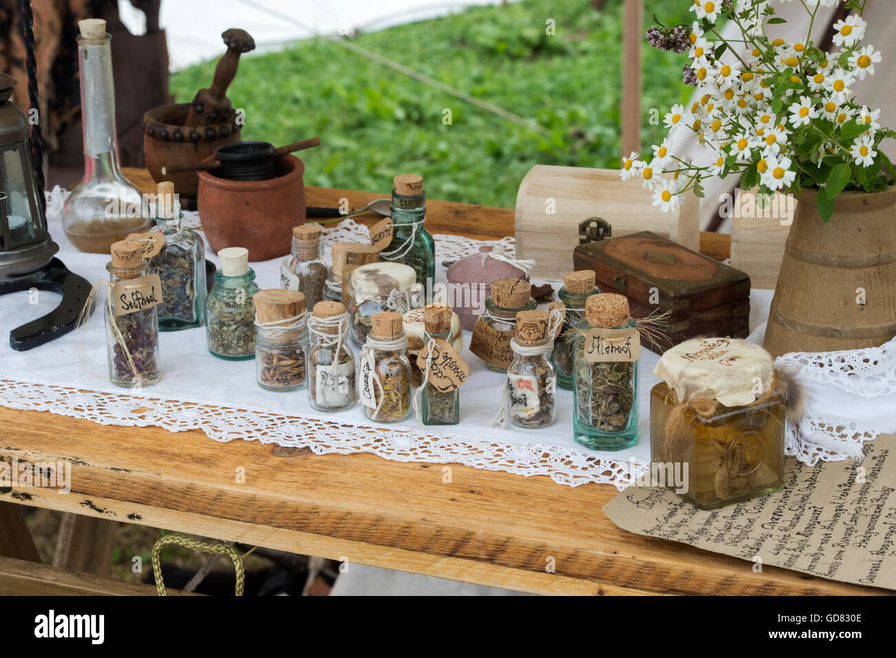 Herbalists table with bottles of herbs at at the Tewkesbury medieval ...