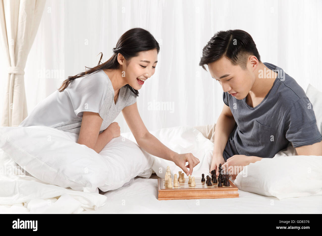 The young couple are playing chess Stock Photo - Alamy