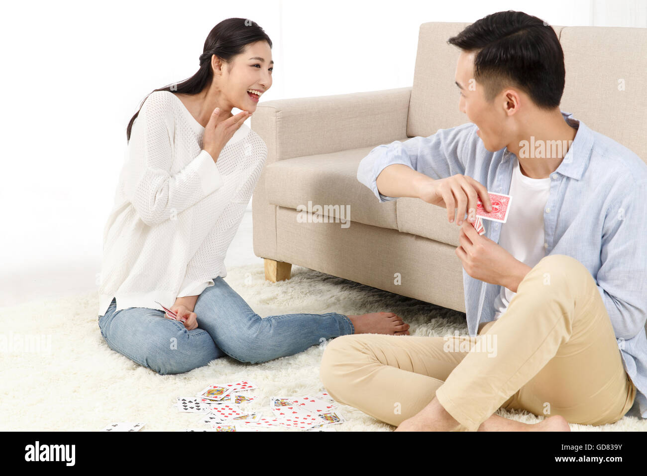 Young lovers playing cards Stock Photo - Alamy