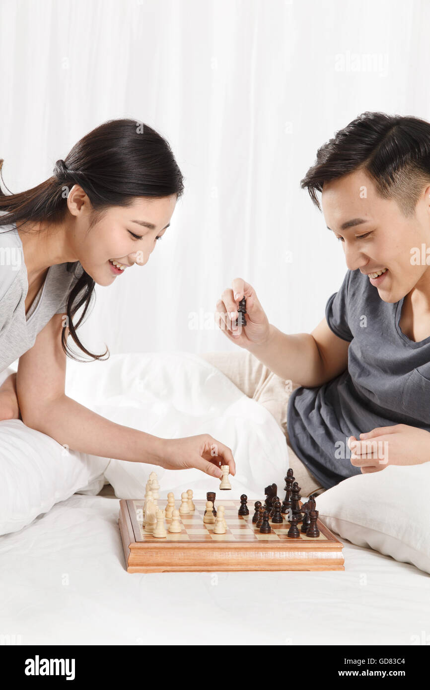 The young couple are playing chess Stock Photo - Alamy