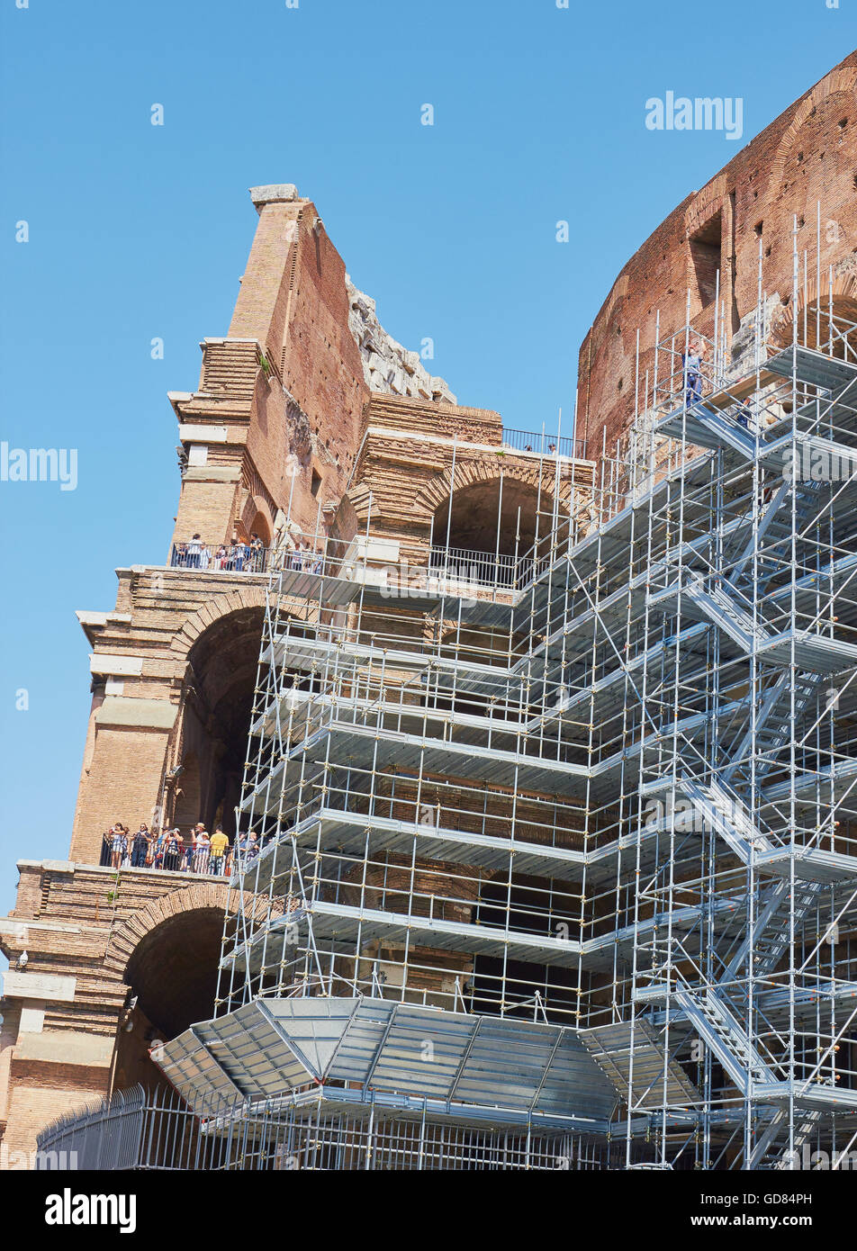 Tourists on observation deck and scaffolding around the Colosseum ...