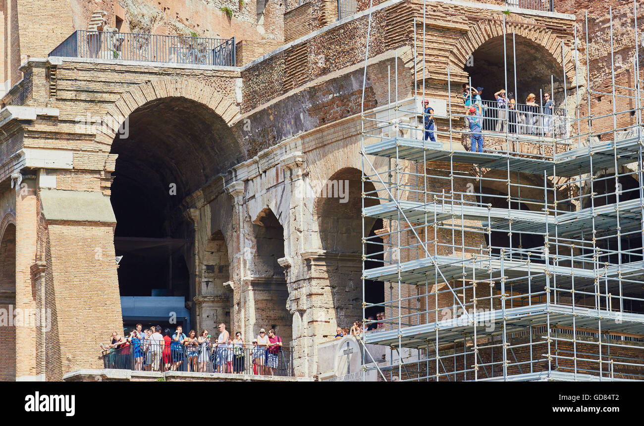 Tourists on observation deck and workmen on scaffolding, Colosseum Rome ...