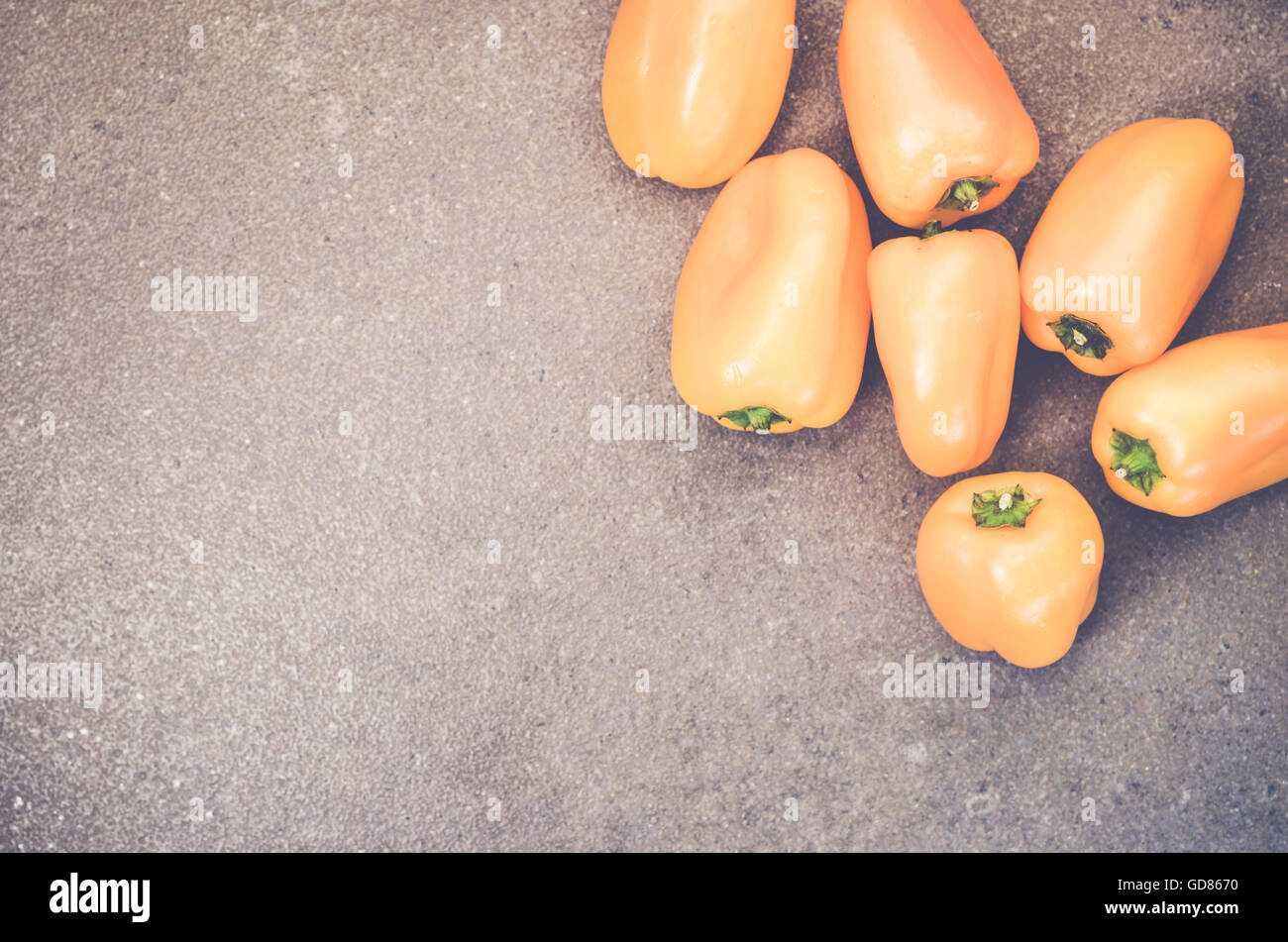 sweet orange pepperoni on a stone surface Stock Photo - Alamy