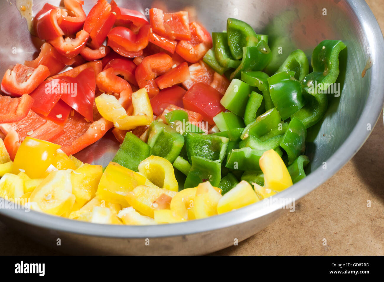 three color bell peppers split In stainless steel containers Stock ...