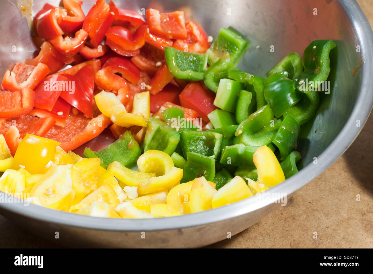 three color bell peppers split In stainless steel containers Stock ...