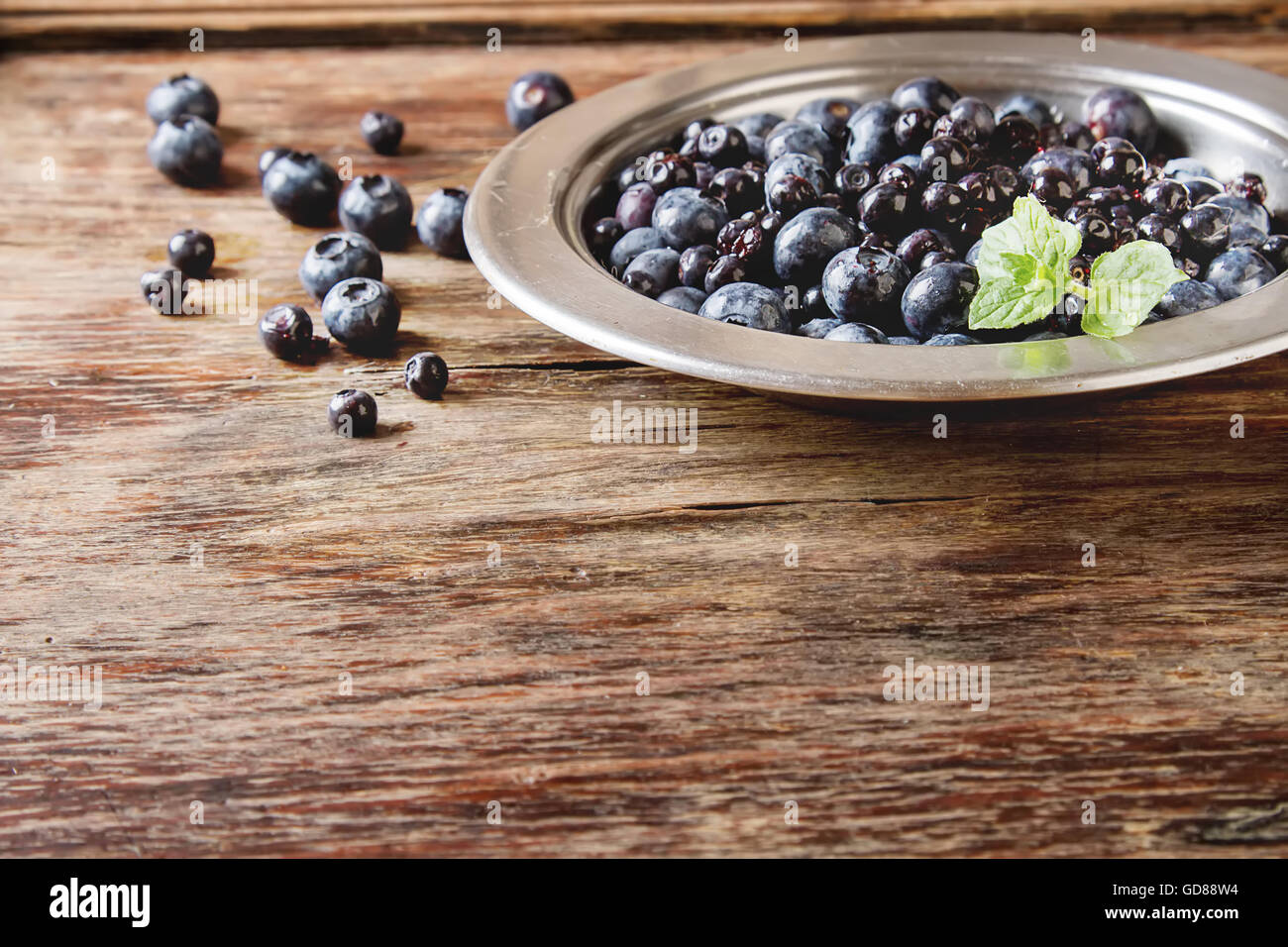 Blue ripe blueberries in a metal plate. wooden background Stock Photo ...