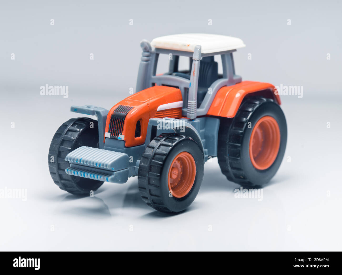 Small red toy tractor on light background, shallow depth of field Stock ...