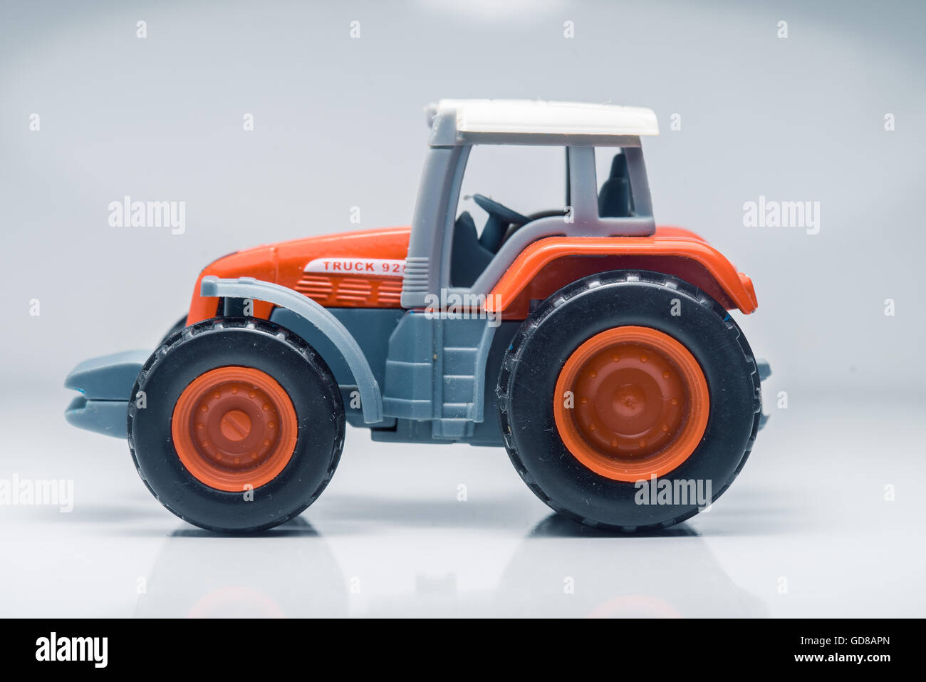 Small red toy tractor on light background, shallow depth of field Stock ...