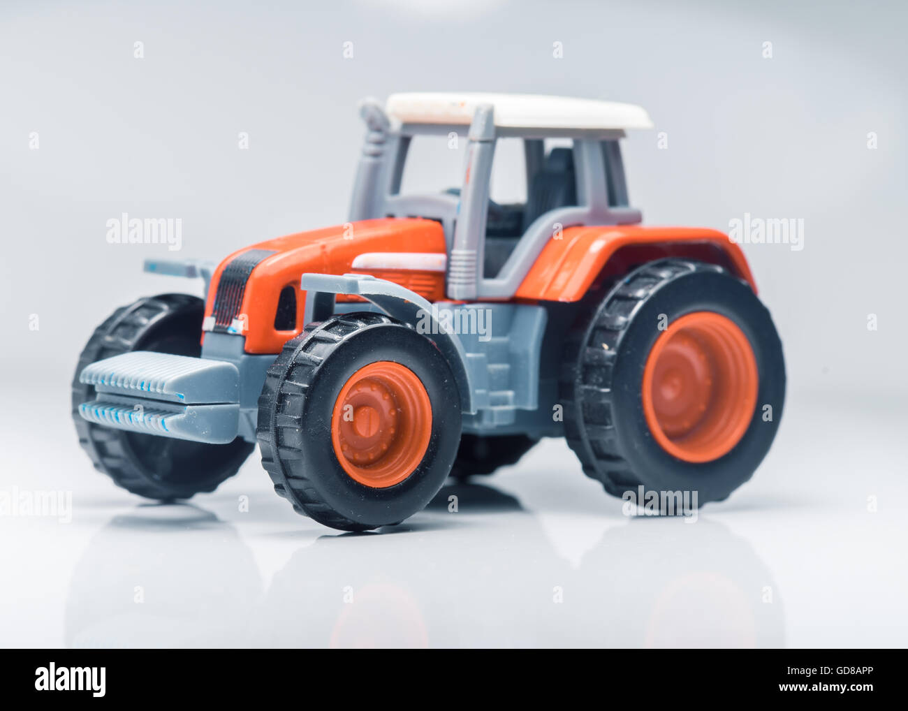 Small red toy tractor on light background, shallow depth of field Stock ...