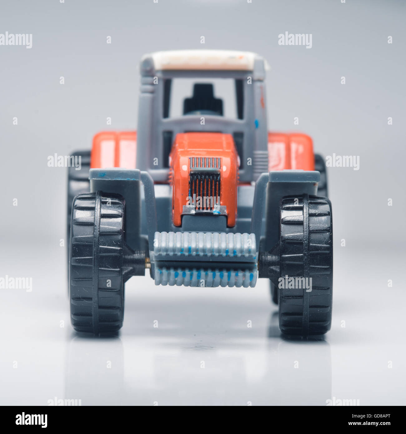 Small red toy tractor on light background, shallow depth of field Stock ...