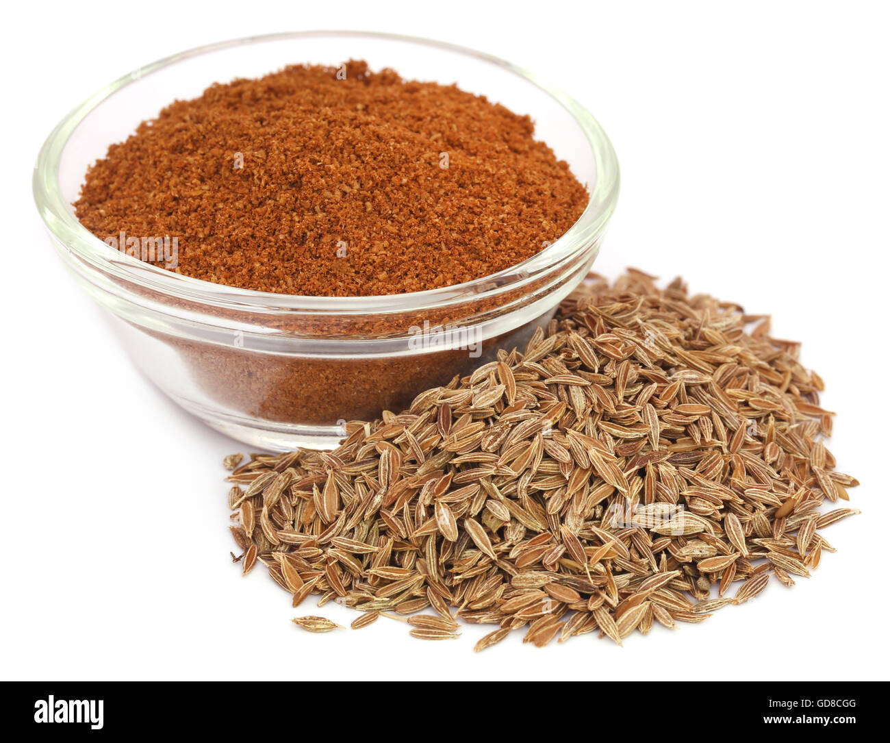 Crushed cumin in a bowl over white background Stock Photo - Alamy