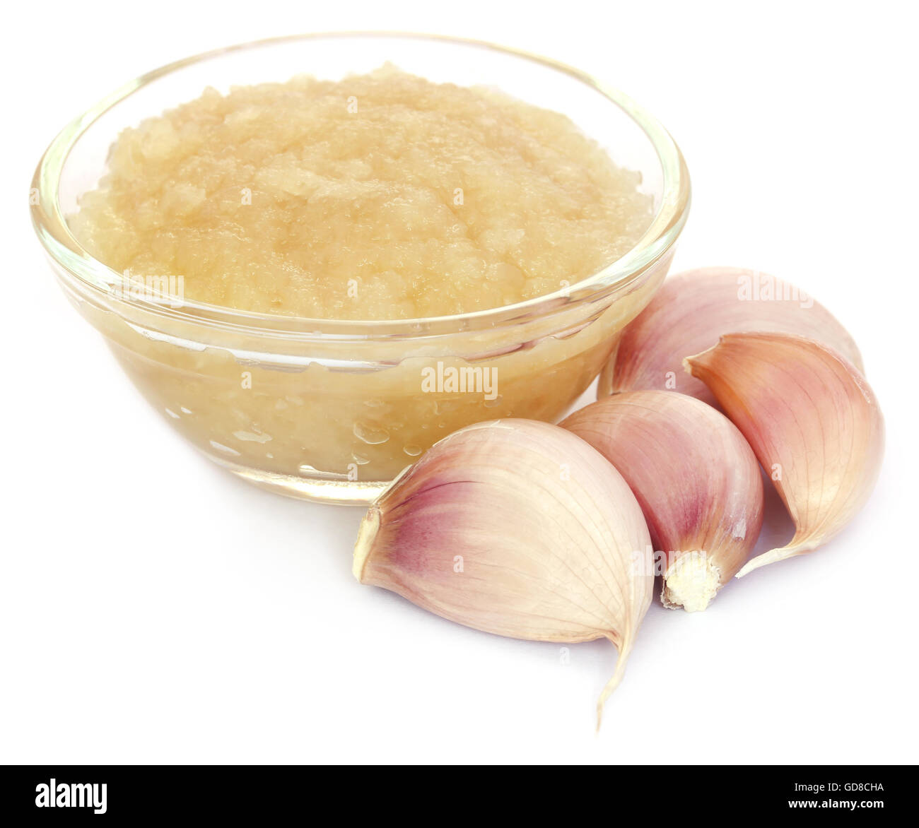 Crushed garlic with whole ones over white background Stock Photo - Alamy