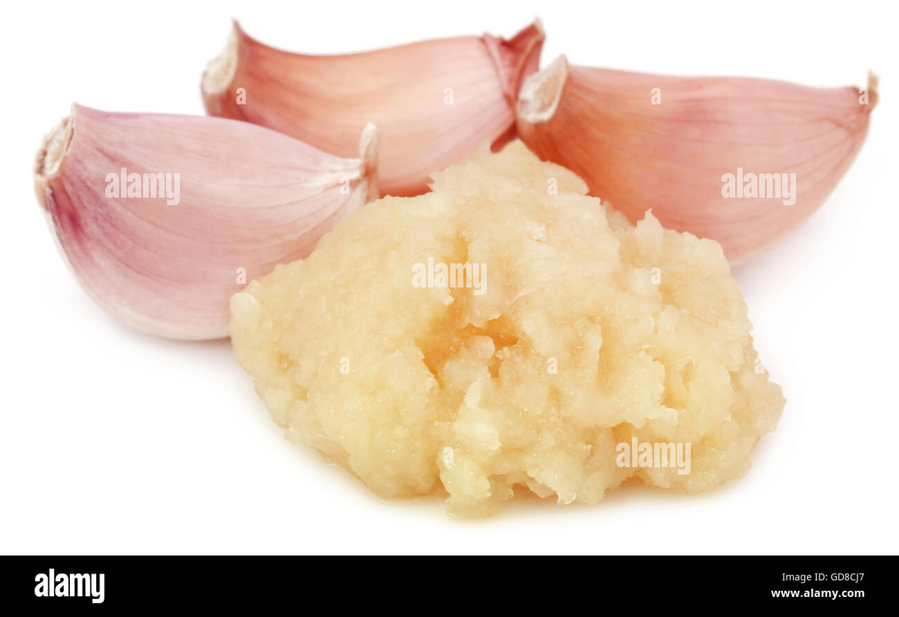 Crushed garlic with whole ones over white background Stock Photo - Alamy