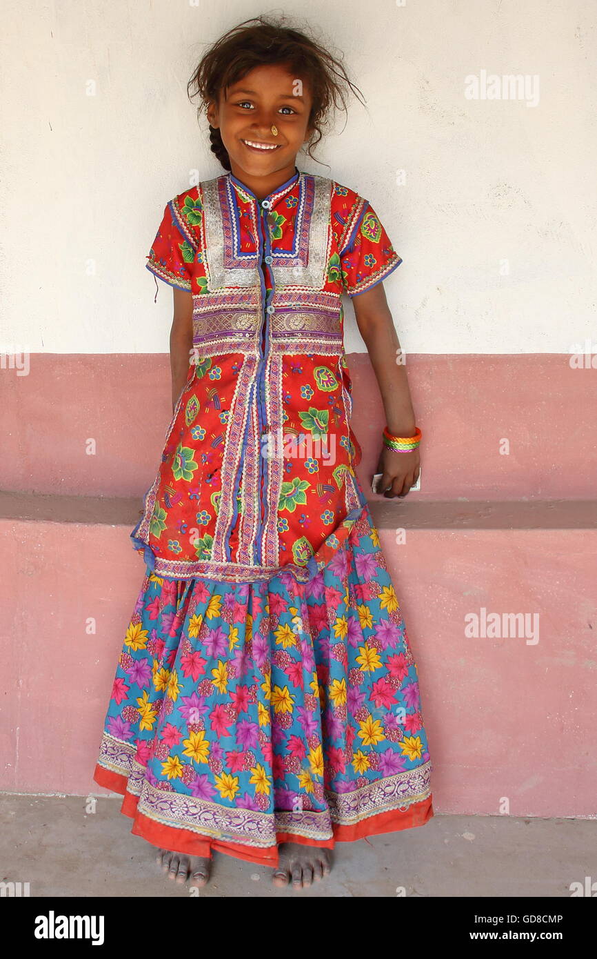 Portrait of a cute and colourful little girl in Hodka, local village ...