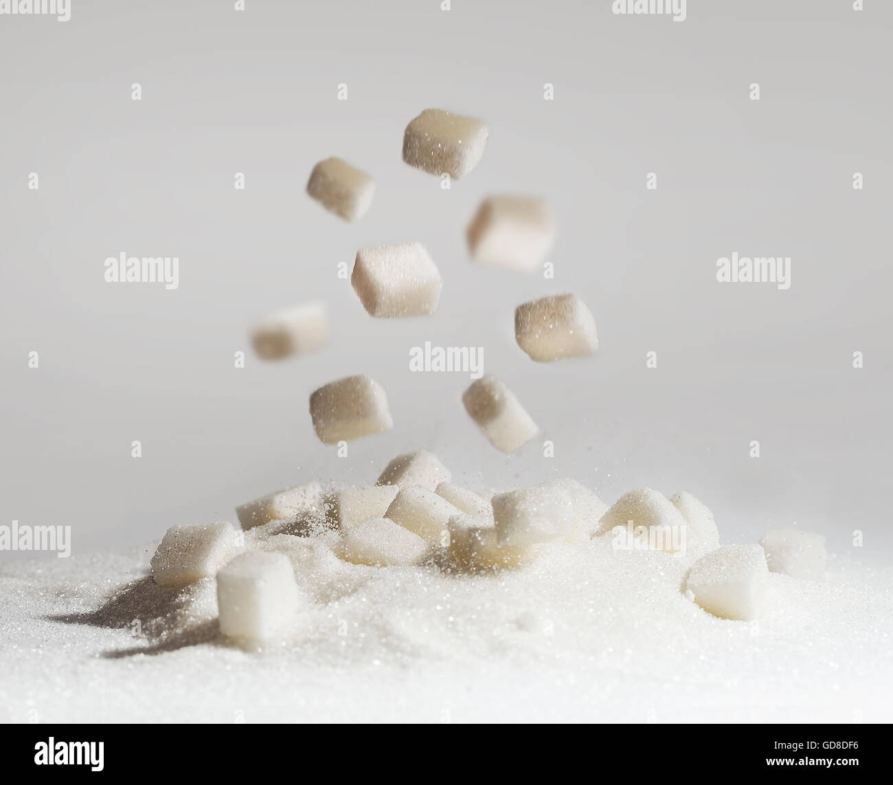 Sugar cube is falling down on a pile of sugar Stock Photo - Alamy