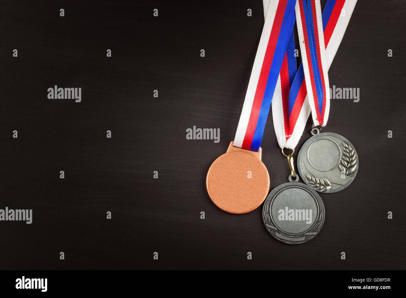Sports medals on a wooden background. Collection of medals for the ...