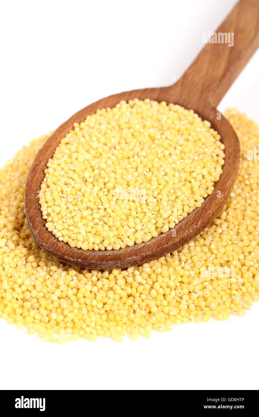 Millet Grains on wooden spoon. Isolated on white background Stock Photo ...