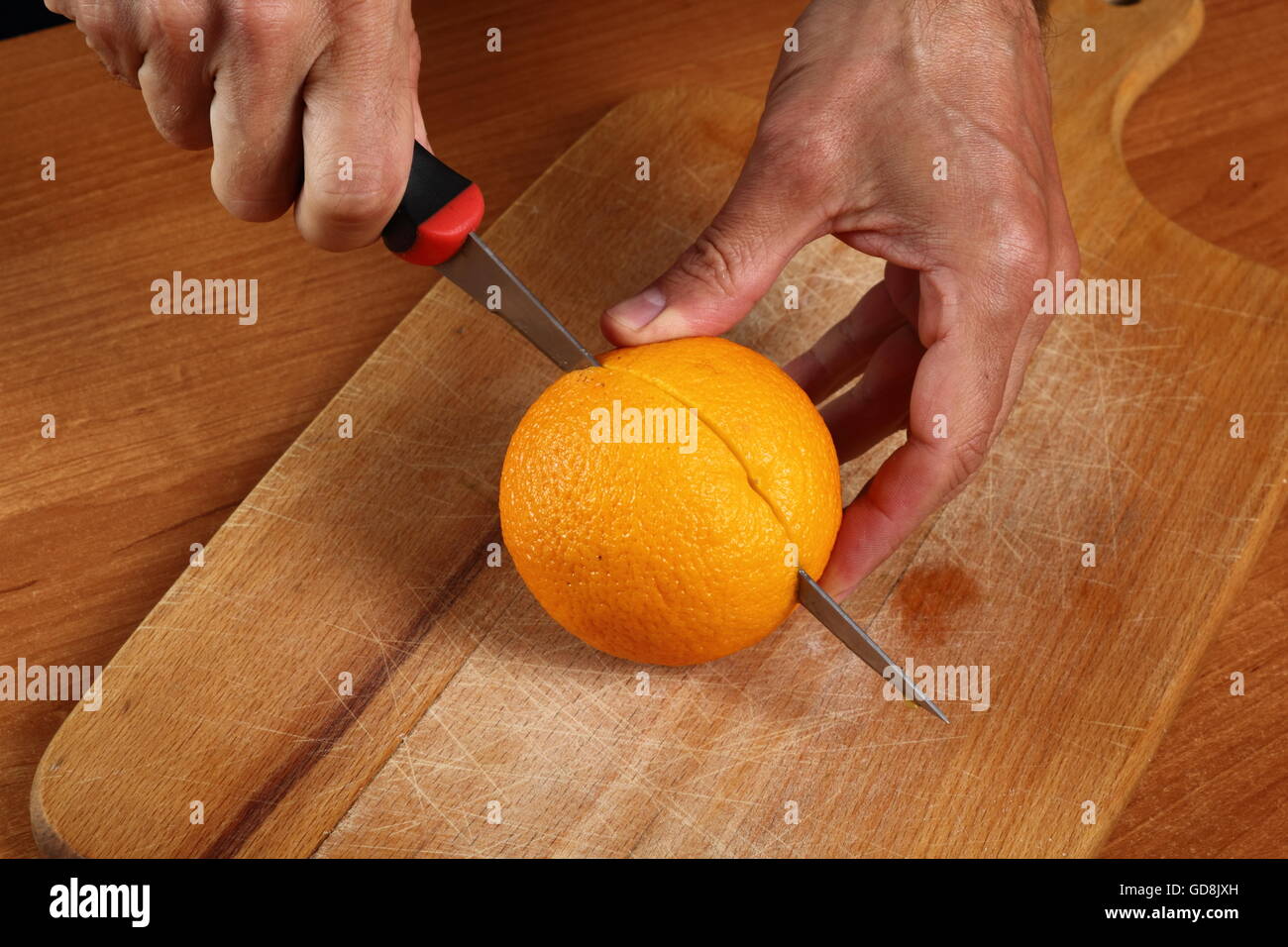 Cutting Orange in half Stock Photo - Alamy