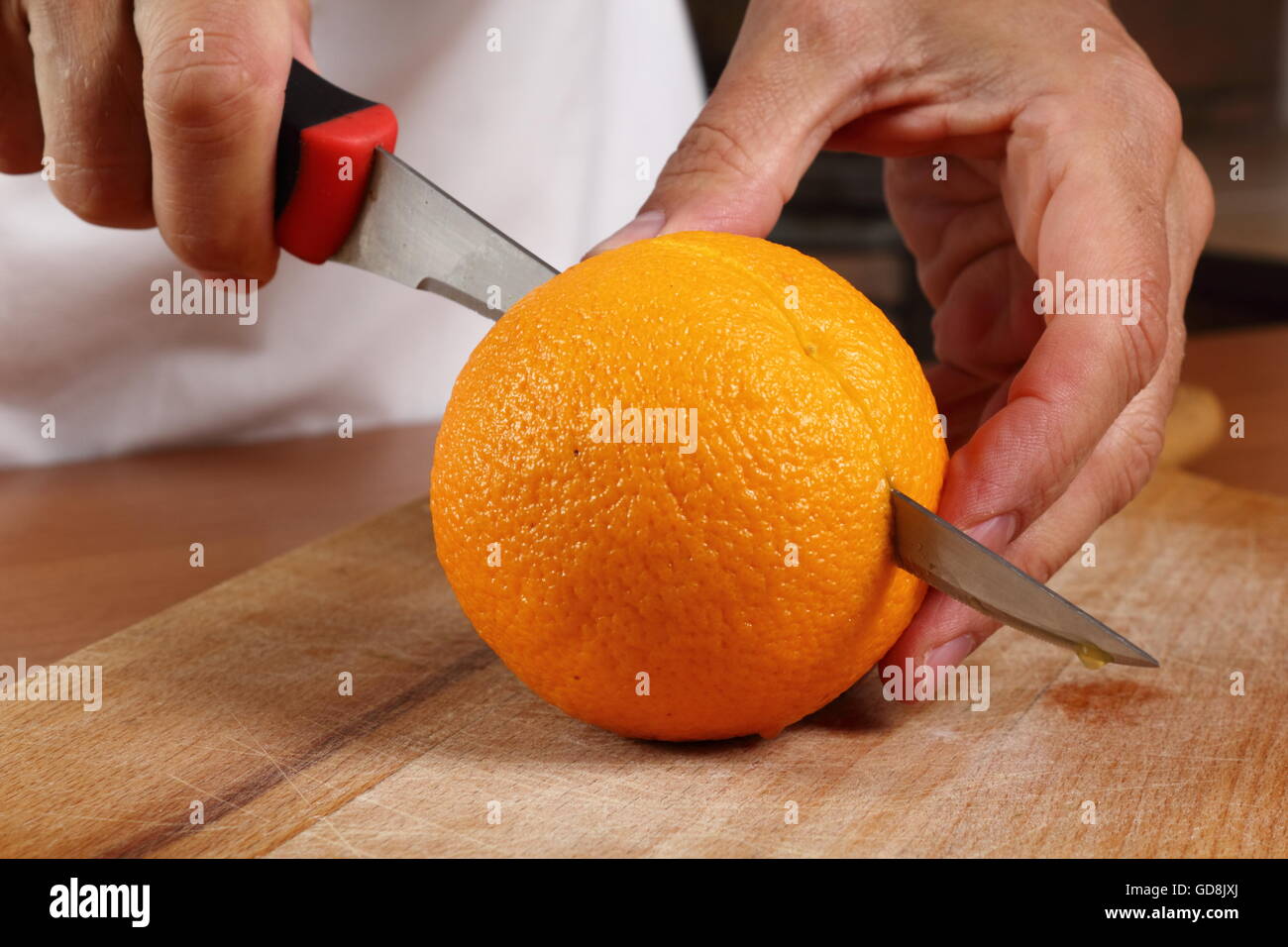 Cutting Orange in half Stock Photo - Alamy