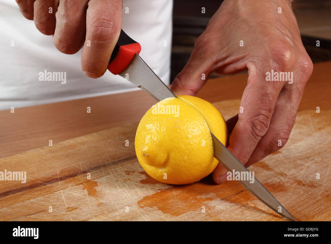 Cutting Lemon in half Stock Photo - Alamy