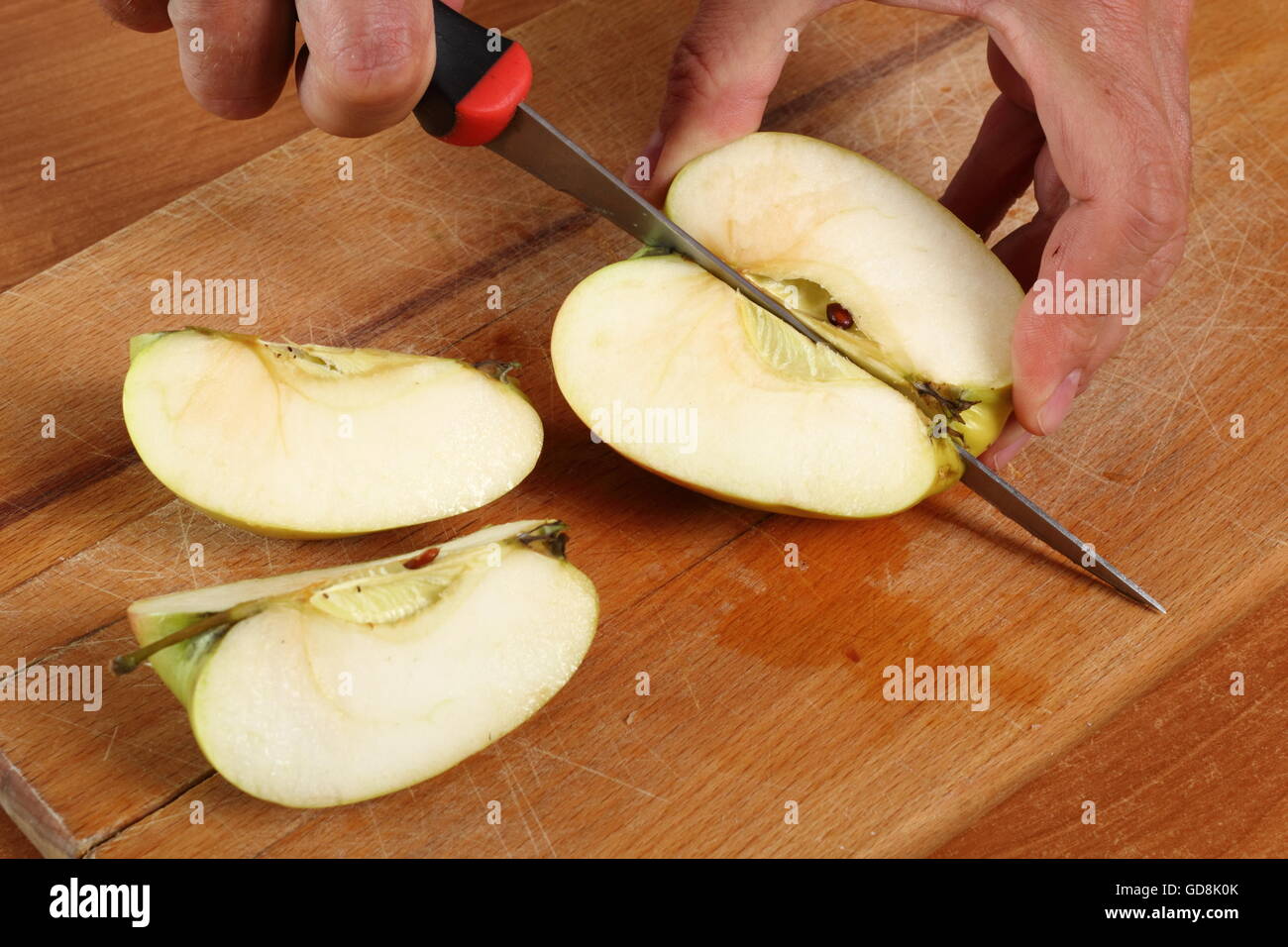 Cutting Apple into pieces Stock Photo - Alamy