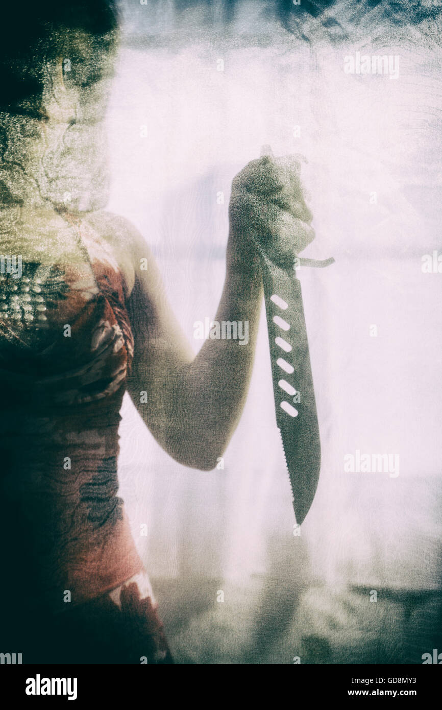 Woman holding a dagger Stock Photo - Alamy