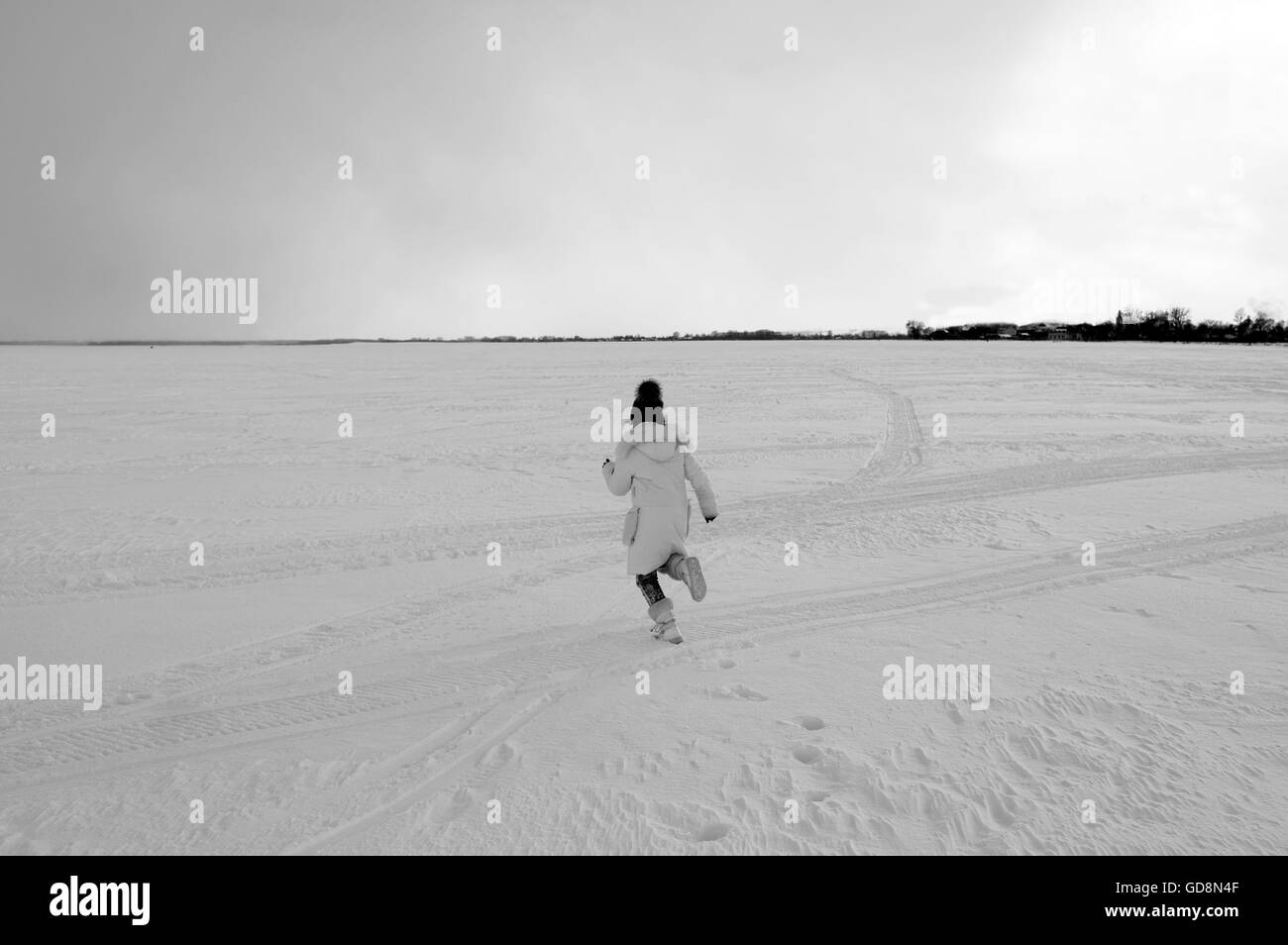 Child running away snow hi-res stock photography and images - Alamy