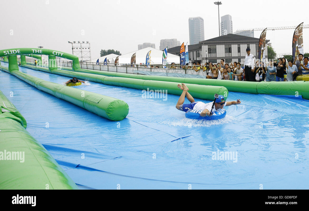 Shanghai, China. 13th July, 2016. Actor Zheng Kai (from) slides down ...