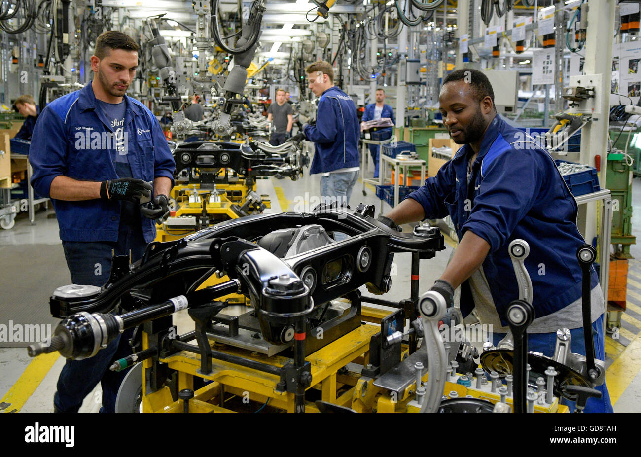Hamburg, Germany. 13th July, 2016. Technicians assemble vehicle axles ...