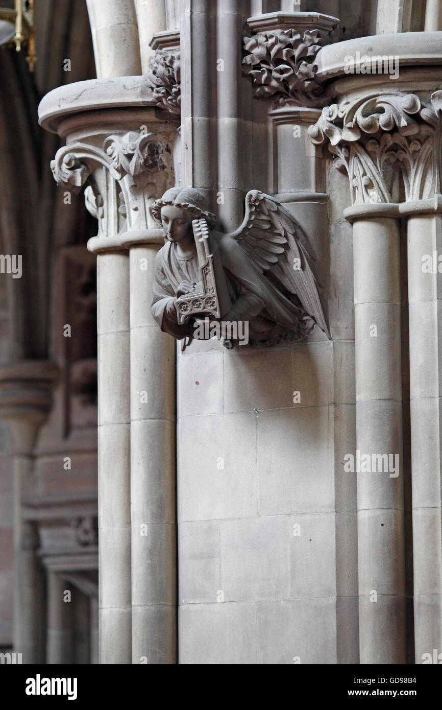 stone carving of an angel playing a small pipe organ. Lichfield ...