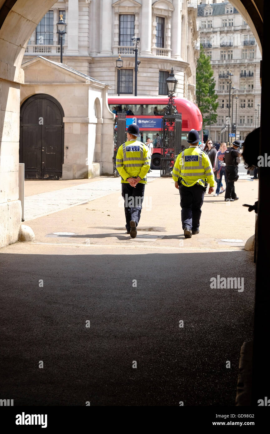 Two London police officers in defective yellow jackets patrol the Horse ...