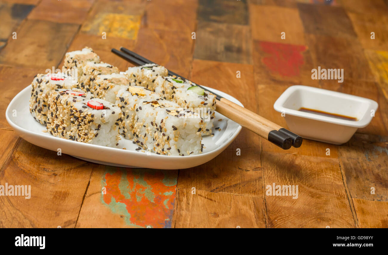 Surimi, egg, tuna and cucumber maki sushi with dark and light sesame ...