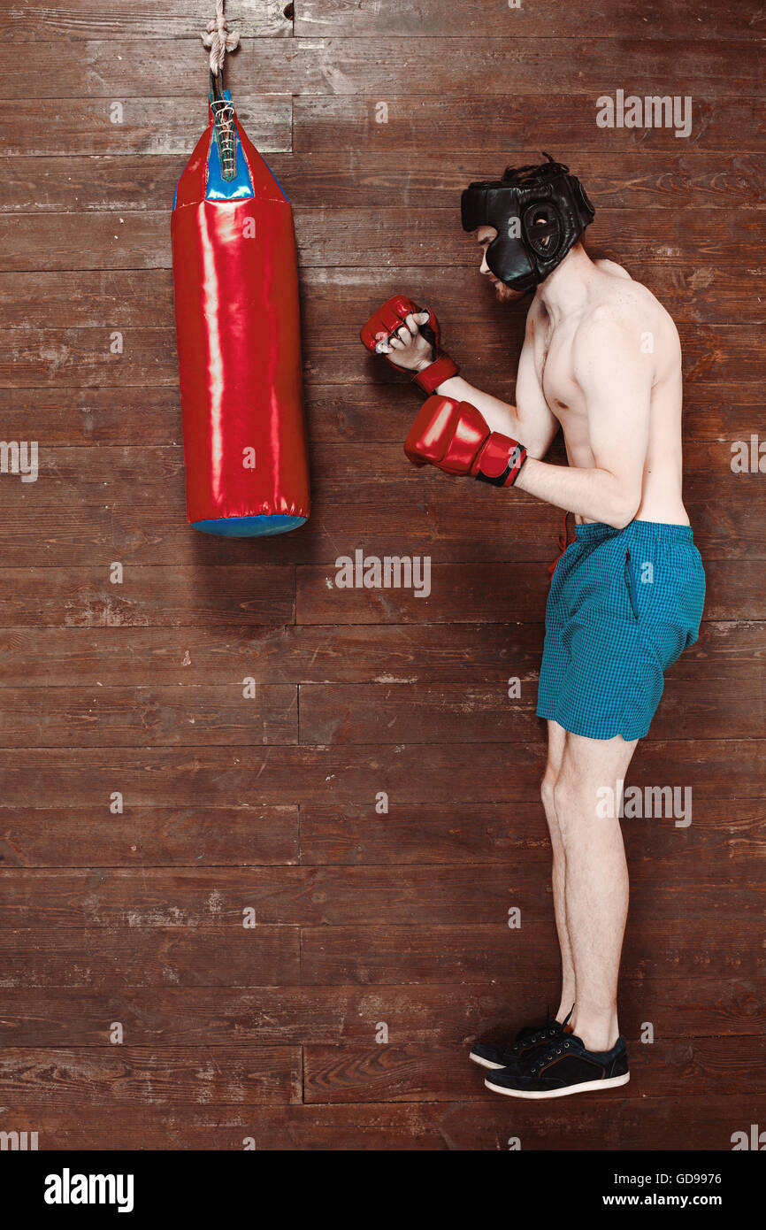 Top view photo of handsome young sportsman on wooden floor. Man with ...