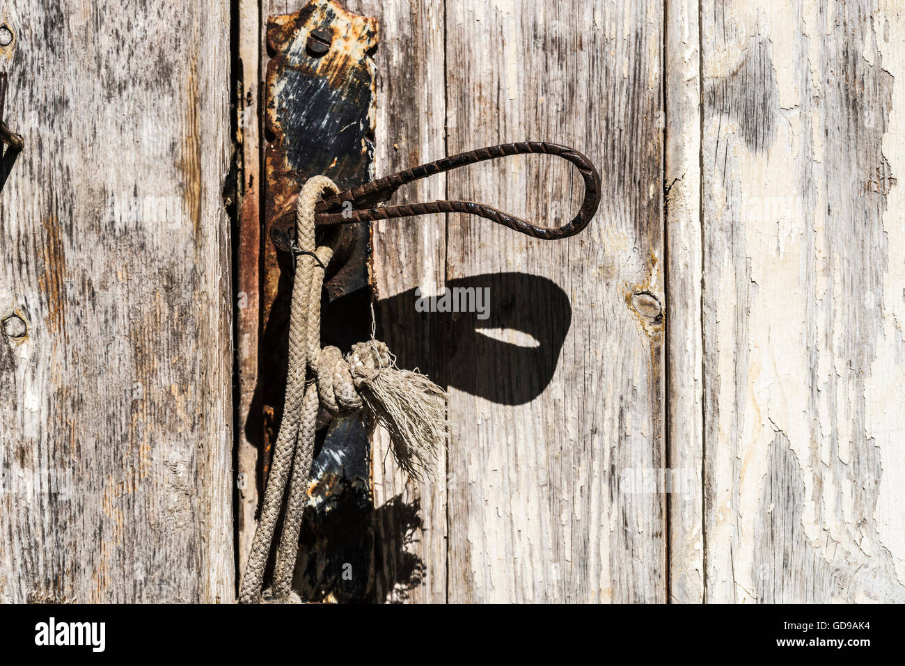 Closeup of a lock with a rope tied on old wood as background Stock ...