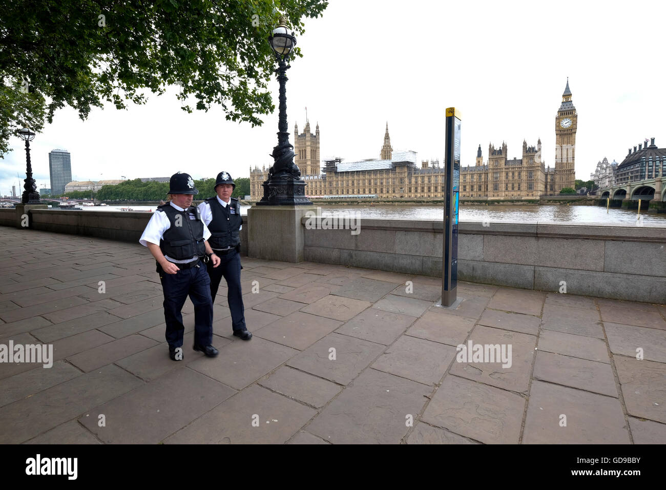 Two London police officers patrol on the South Bank of the river Thames ...