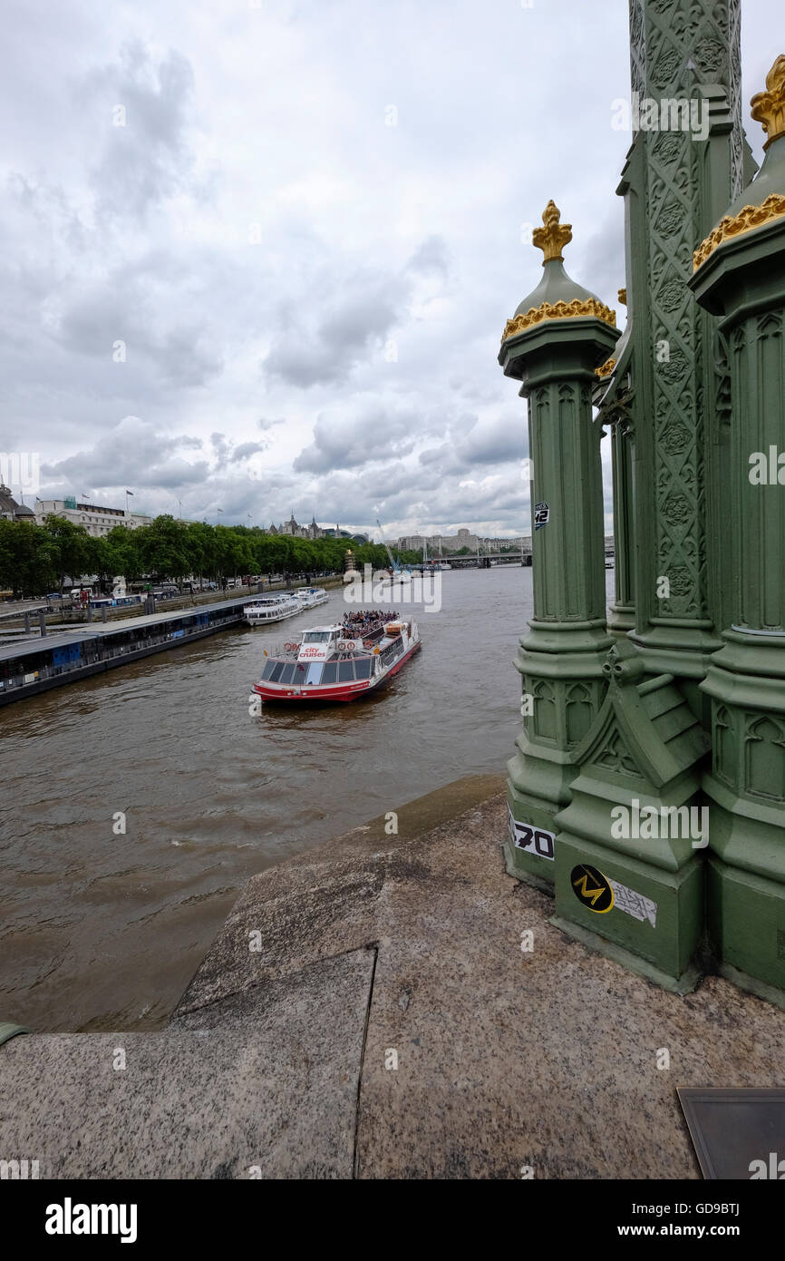 A river tour boat approaches Westminster Bridge over the river Thames ...