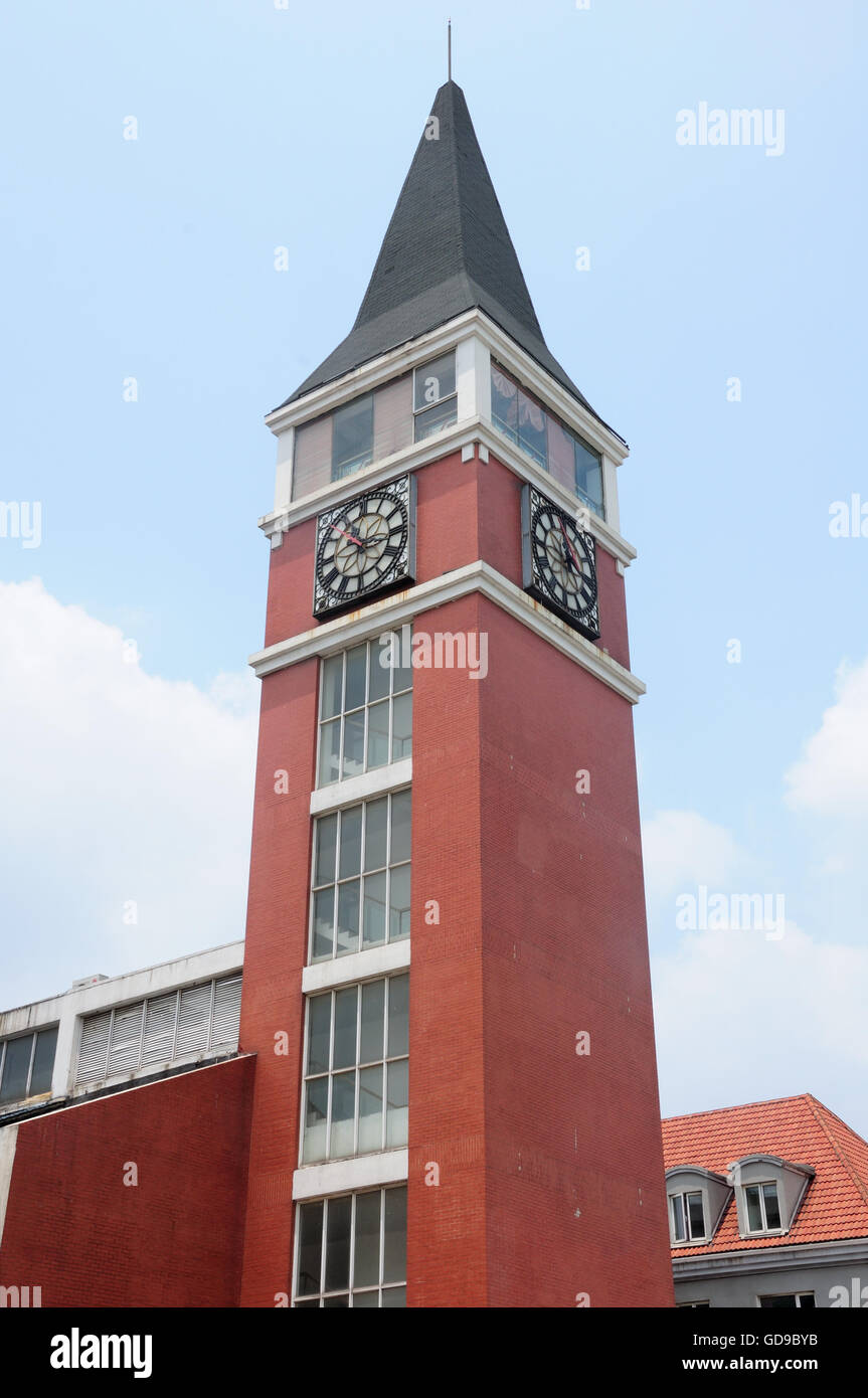 The exterior of a brick clock tower in the Baoshan district of Shanghai ...