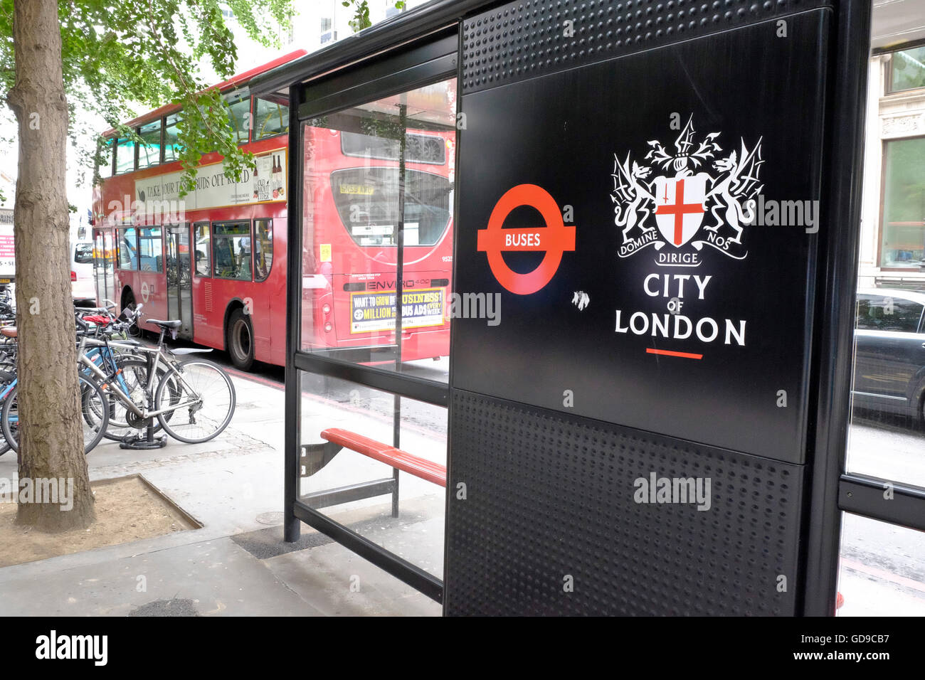 The on a bus stop with the iconic red double decker in the background ...