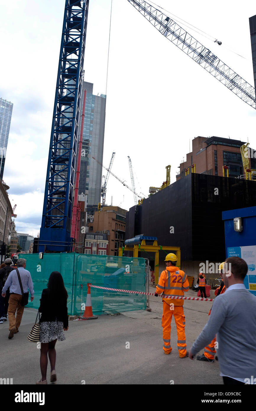 A construction site with construction workers in bright orange overalls ...