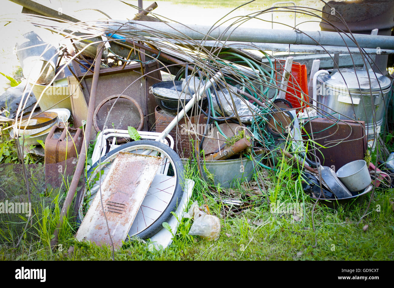 A heap of scrap metal and trash on the grass Stock Photo - Alamy