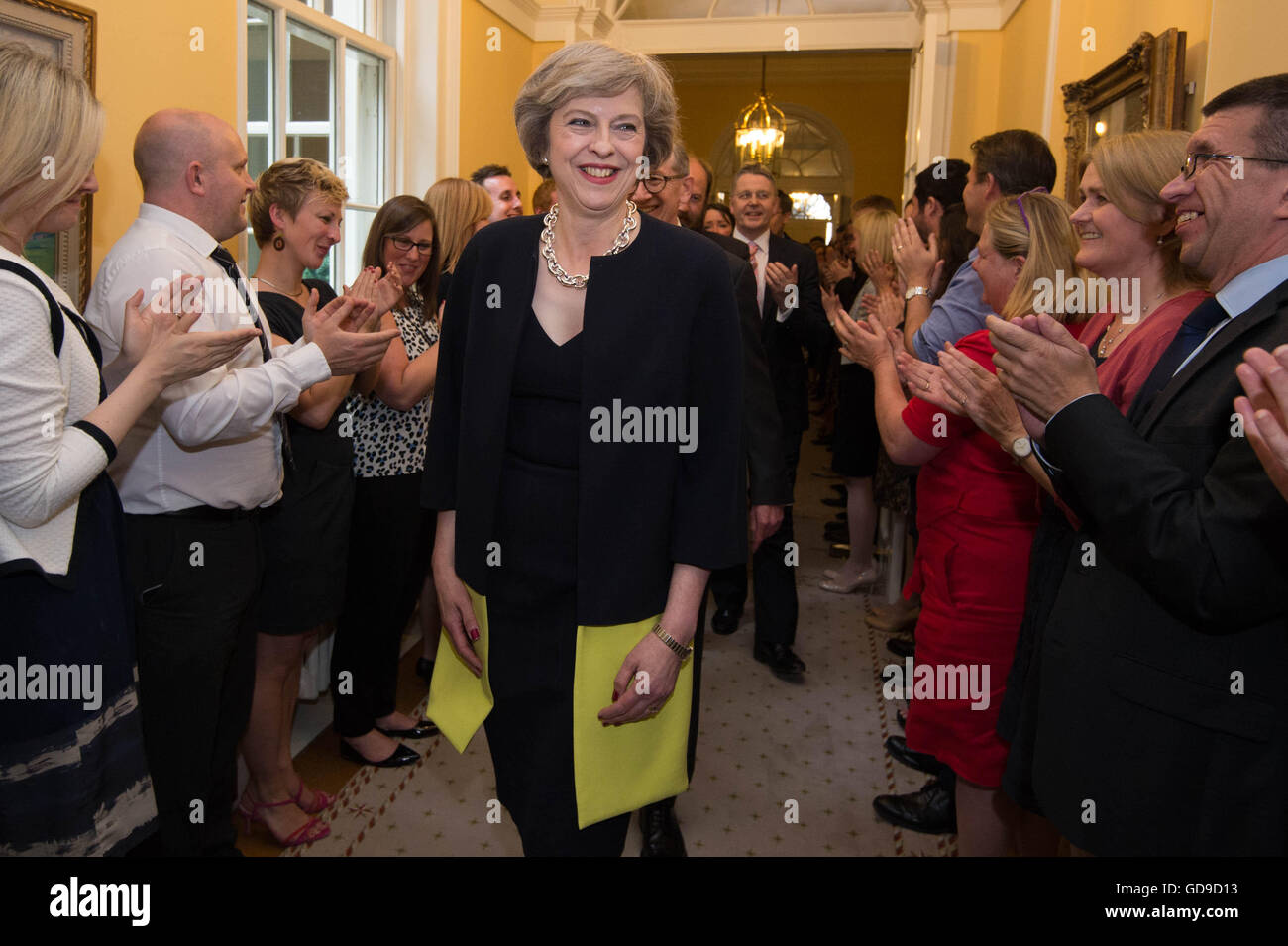 Staff clap as new Prime Minister Theresa May, followed by her husband ...