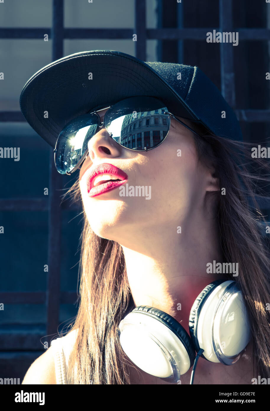 A beautiful young Hip Hop Rapper girl with Headphones in a urban ...