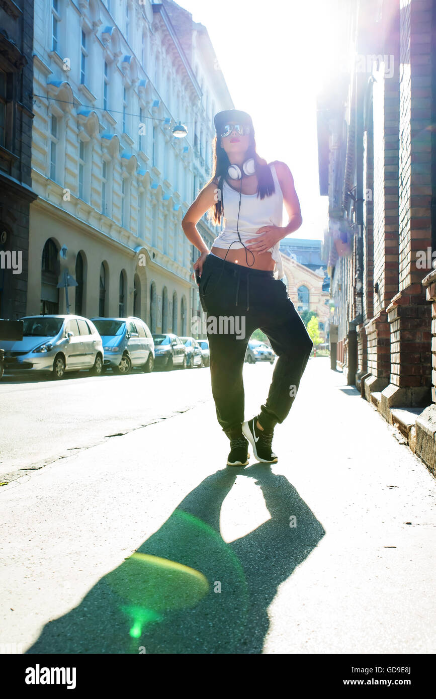 A beautiful young Hip Hop Rapper girl with Headphones in a urban ...